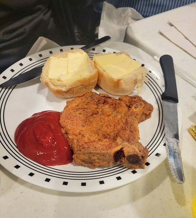 Simple pleasures done right: a perfectly seasoned pork chop with buttered bread that reminds you why classics never go out of style.