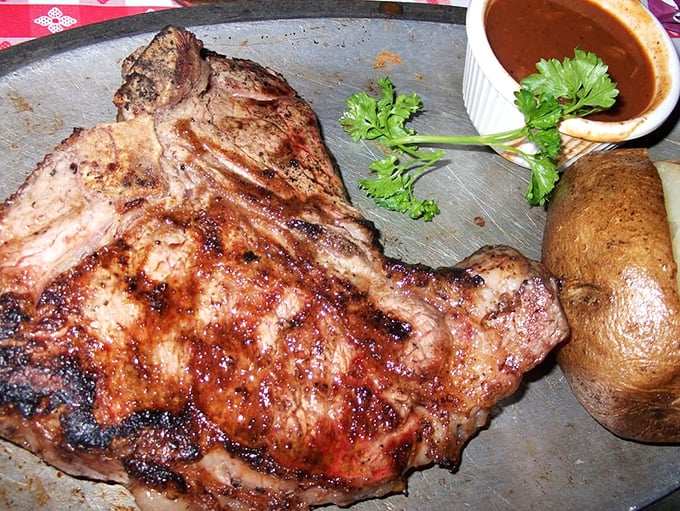 This porterhouse doesn't just sit on the plate—it commands it. The bone isn't just for show; it's nature's handle for the ultimate meat experience.
