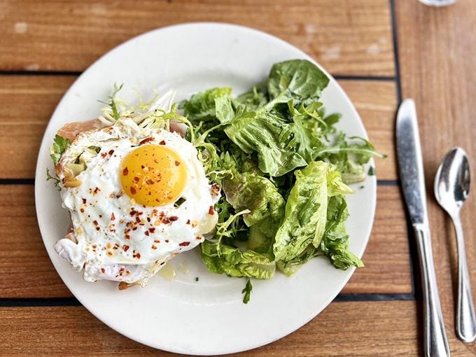 A simple green salad alongside a perfectly cooked egg—proof that breakfast doesn't always need to be a guilt trip.