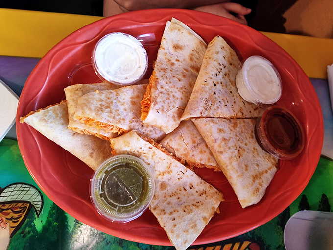 The quesadilla achieves that perfect golden exterior while hiding a treasure of melted cheese within—like a delicious piñata waiting to be broken.