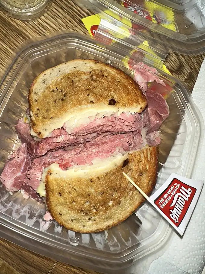 The Reuben to end all Reubens – a tower of meat, sauerkraut, and melted Swiss that requires strategic planning just to take a bite.