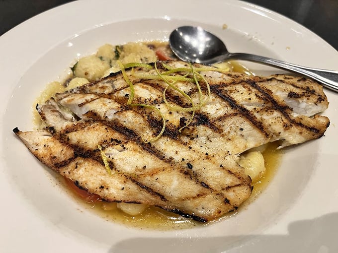 Perfectly grilled fish resting in a delicate sauce—proof that simplicity, when executed with precision, creates the most memorable meals.