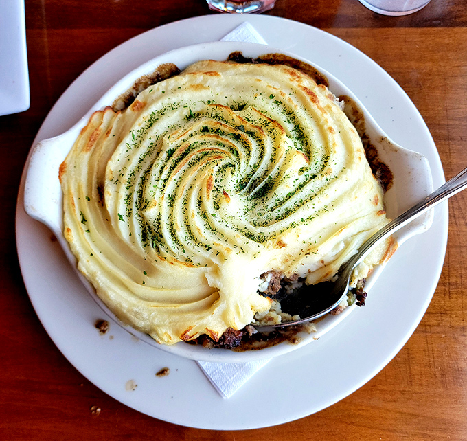 Shepherd's pie with a hypnotic swirl of mashed potatoes that says, "Yes, comfort food can be beautiful too," hiding savory treasures beneath.