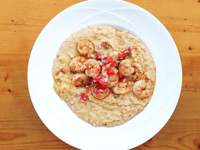 Creamy grits crowned with plump, seasoned shrimp and fresh pico de gallo—Southern comfort with a chef's touch.