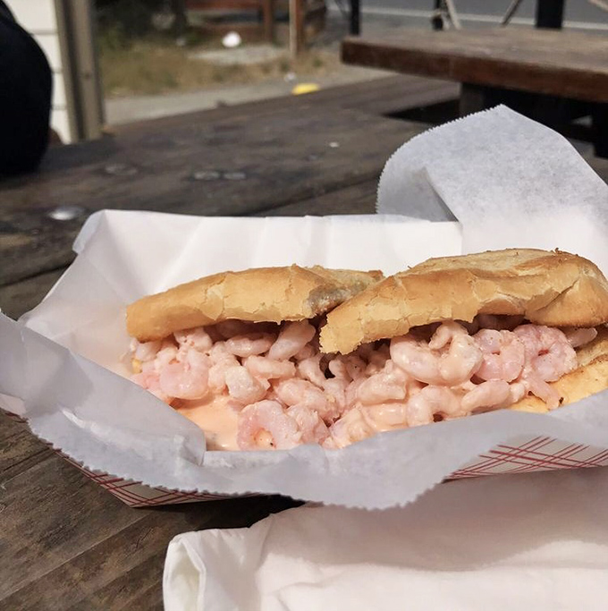 The shrimp sandwich in all its unadorned glory – proof that when seafood is this fresh, simplicity becomes the ultimate luxury.