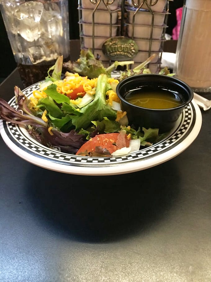 Even the side salad gets special treatment here. Fresh greens, tomatoes, and cheese with dressing on the side – because sometimes you need something green before pie shake indulgence.