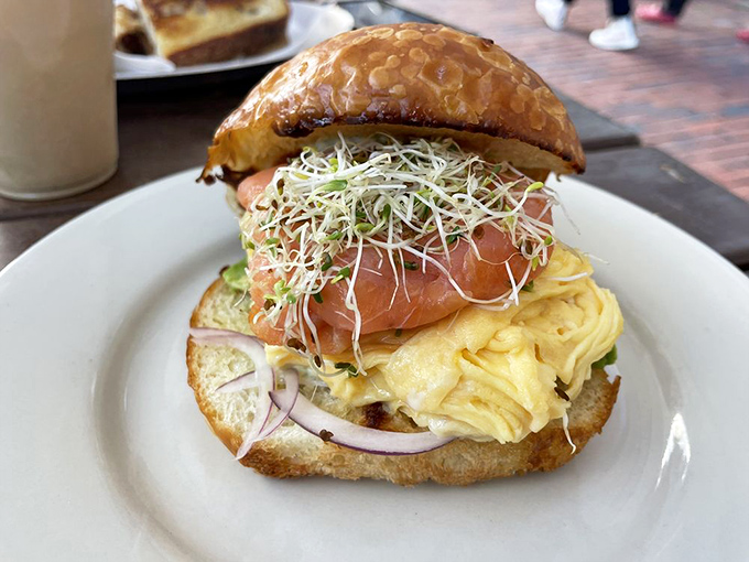 This isn't just a sandwich; it's architecture. Layers of smoked salmon, fluffy eggs, and fresh sprouts create the Frank Gehry of breakfast buildings.