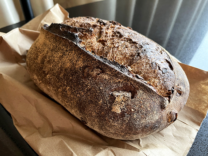 A country loaf with the kind of crust that sings when you squeeze it—the bread equivalent of a perfectly aged leather jacket.