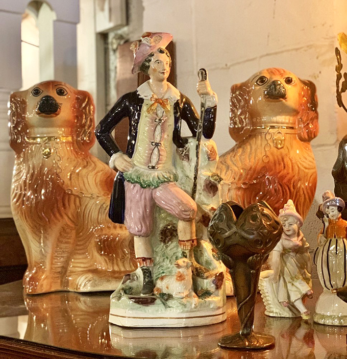 These Staffordshire dogs and figurines once graced Victorian mantels, their glazed expressions silently witnessing family dramas long before television arrived to entertain us.