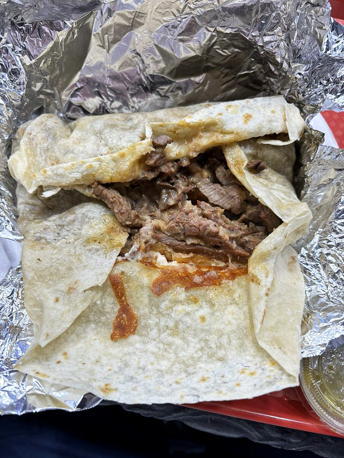 Peek inside this tortilla treasure chest and discover why people drive for hours. The meat-to-tortilla ratio here deserves a mathematical award.