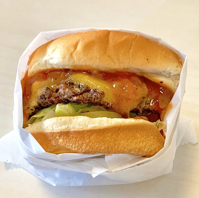 Behold the Steakburger in all its glory – the perfect ratio of meat to cheese to sauce, like a mathematical equation that equals pure satisfaction.