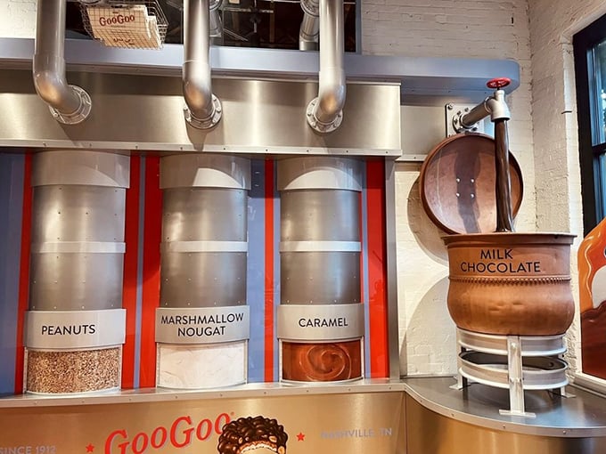 That cross-section reveals the architectural wonder of a Goo Goo Cluster – layers of caramel, nougat, and nuts embraced by chocolate like a sweet group hug.