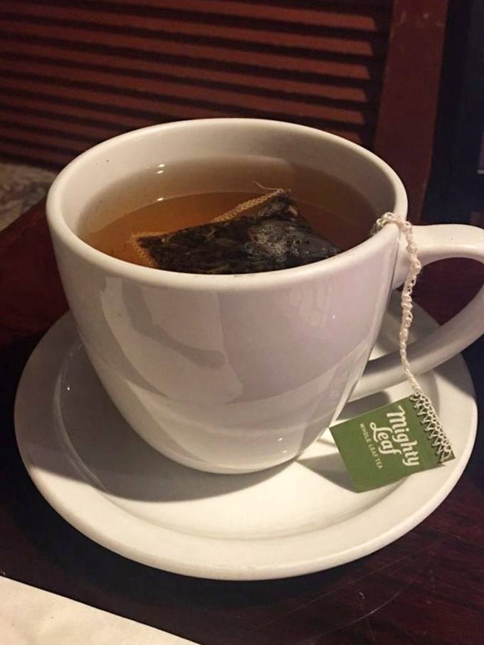 A proper cup of tea, complete with string dangling over the edge—civilization's most civilized pause button in ceramic form.