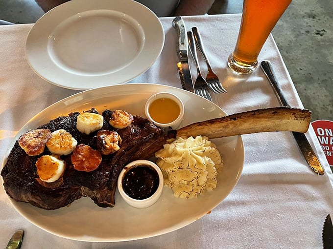 The tomahawk steak commands respect like a Viking warrior, complete with scallop reinforcements for maximum impact.