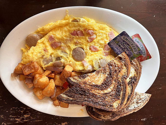 An omelet that's having an identity crisis in the best possible way—packed with sausage, ham, and potatoes, it's breakfast that eats like dinner.