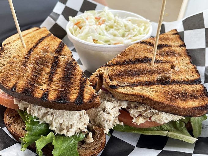 A sandwich that doesn't need to shout to be heard. Perfectly grilled bread, generous filling, and that homemade coleslaw sidekick—lunch perfection achieved.