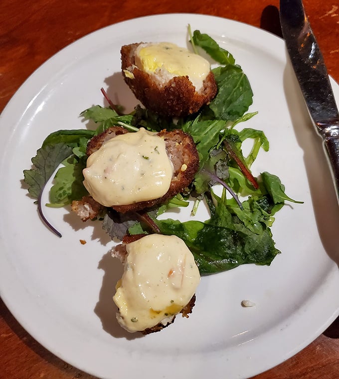 These aren't your average meatballs – they're dressed for a royal occasion, perched atop greens and crowned with a sauce that demands to be savored.