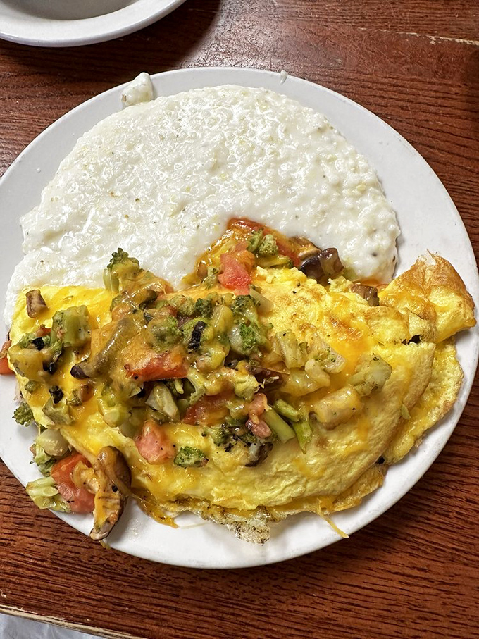 The vegetable omelet that makes eating your greens feel like cheating. Broccoli, tomatoes, and cheese transform morning eggs into a garden celebration.