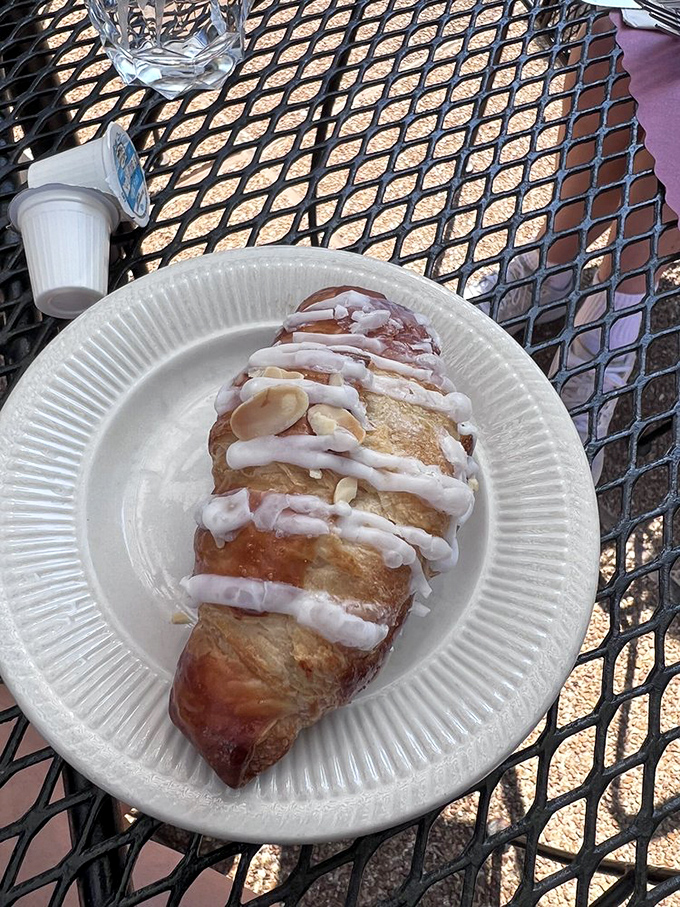 This isn't just a croissant—it's a buttery, flaky miracle drizzled with icing that makes Monday mornings bearable again.