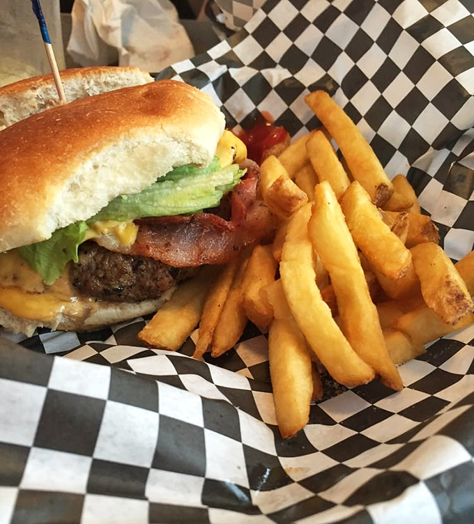 A burger that requires a game plan before the first bite. Notice how the cheese melts just right—that's not an accident, folks.