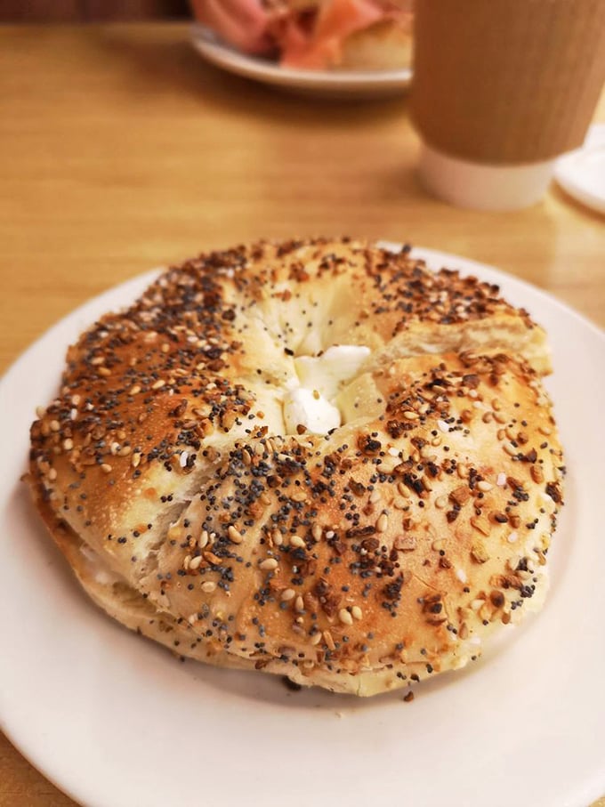 This isn't just any bagel – it's a New York bagel with enough seeds to start a garden and enough chew to remind you you're alive.