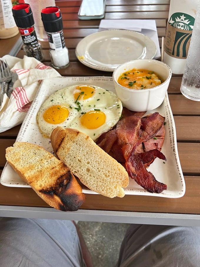 The breakfast plate that launched a thousand road trips. Perfectly cooked eggs, crispy bacon, and toast that knows its supporting role.