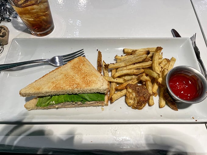 Sometimes simplicity wins the day—a classic sandwich with crisp lettuce peeking out, flanked by golden fries that crackle with each bite.