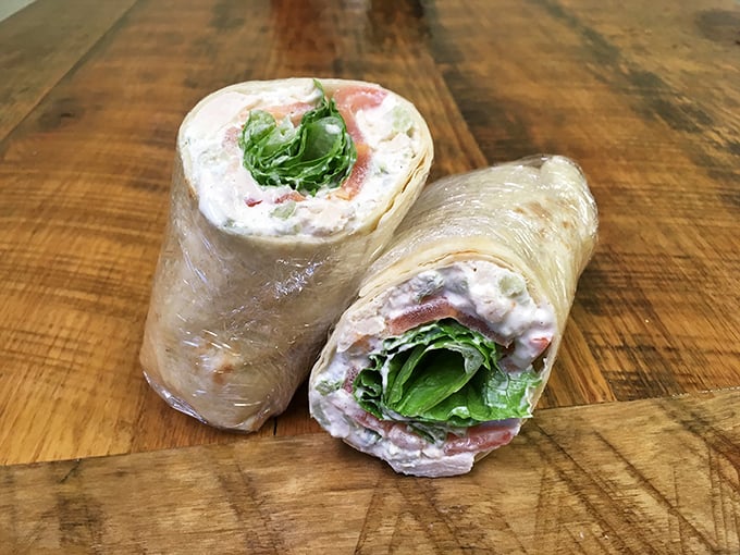 Peek inside this wrap and you'll find a chicken salad that doesn't just speak – it sings with textures and flavors.