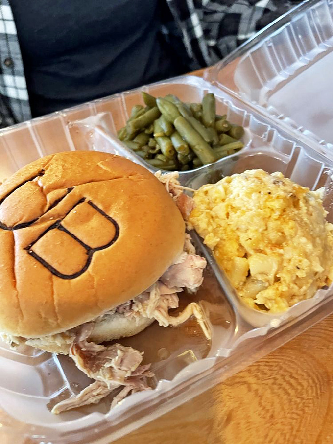This pulled chicken sandwich with its branded bun isn't just lunch—it's edible artwork with mac 'n cheese that could make a southerner weep with joy.