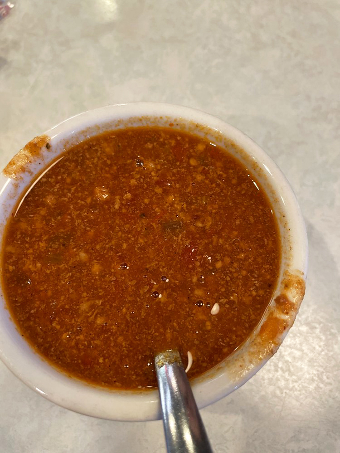 A bowl of chili that's having a serious conversation with your taste buds—spicy, complex, and exactly what you'd hope to find in a proper American diner.