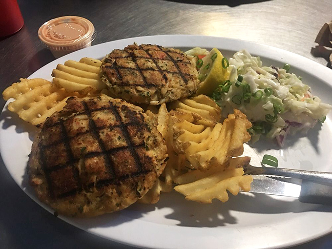These crab cakes aren't hiding behind fillers – they're proudly showcasing their crab meat credentials alongside those signature waffle fries.