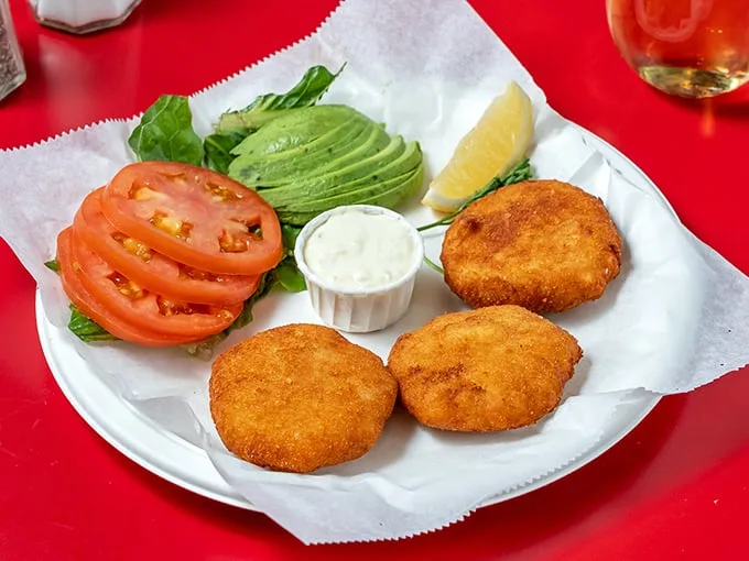 The legendary crab cakes – golden-crisp exterior giving way to sweet, tender crabmeat within. Like finding treasure on a paper plate.