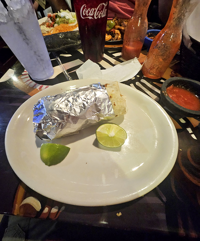 Foil-wrapped happiness waiting to be unleashed. This burrito comes with lime wedges that aren't just garnish—they're essential supporting actors.