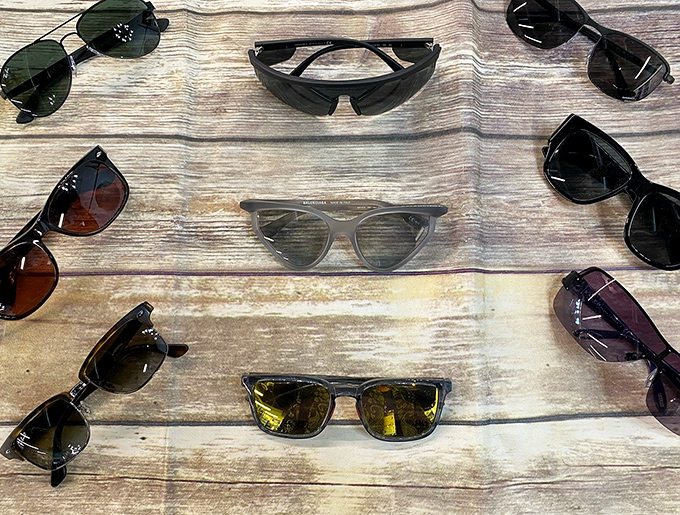 Sunglasses galore! From classic aviators to trendy frames, these shades are arranged like a buffet of cool—just pick your flavor of fabulous.