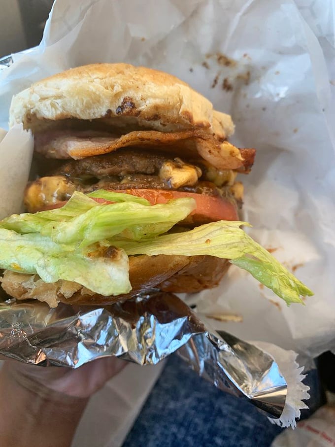 Layer upon layer of beef, cheese, and fresh toppings—this isn't just a burger, it's an architectural achievement worthy of a Cleveland landmark.
