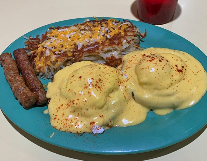 Eggs Benedict done right, with hollandaise that flows like liquid sunshine over perfectly poached eggs and crispy hash browns.