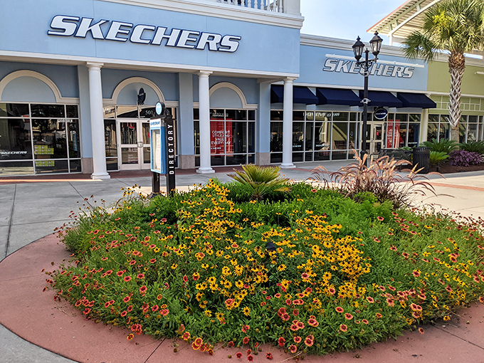 Skechers storefront blooms with carefully tended flower beds, proving even discount shopping can come with a side of Southern garden charm.