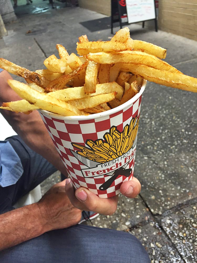 Hand-cut Idaho potatoes transformed into crispy vessels of joy—these fries aren't just a side dish, they're the supporting actor who steals the show.