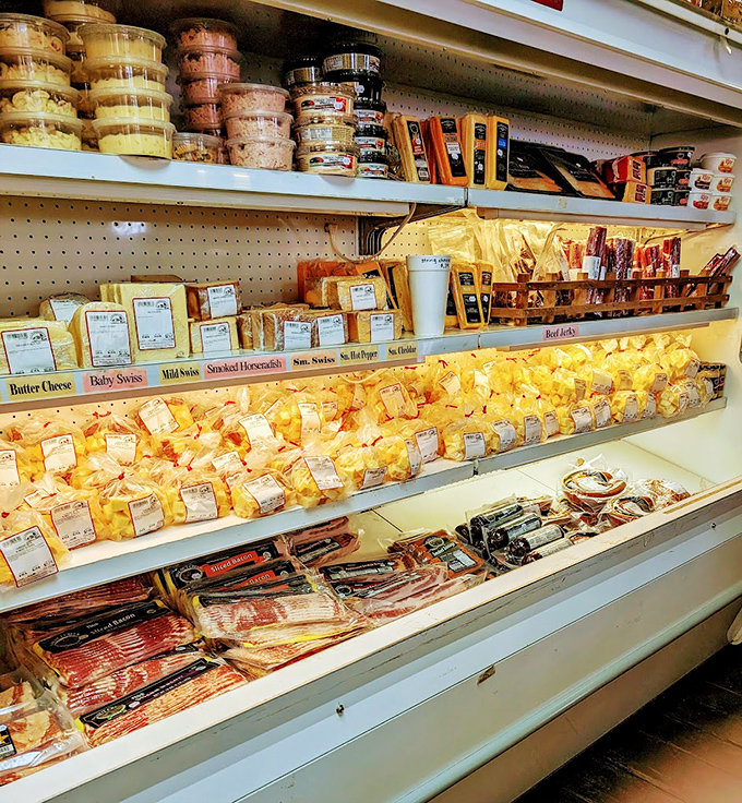 A cheese display that would make Wisconsin blush with pride. Not just dairy—this is a museum of milk's greatest achievements, displayed with reverent care.