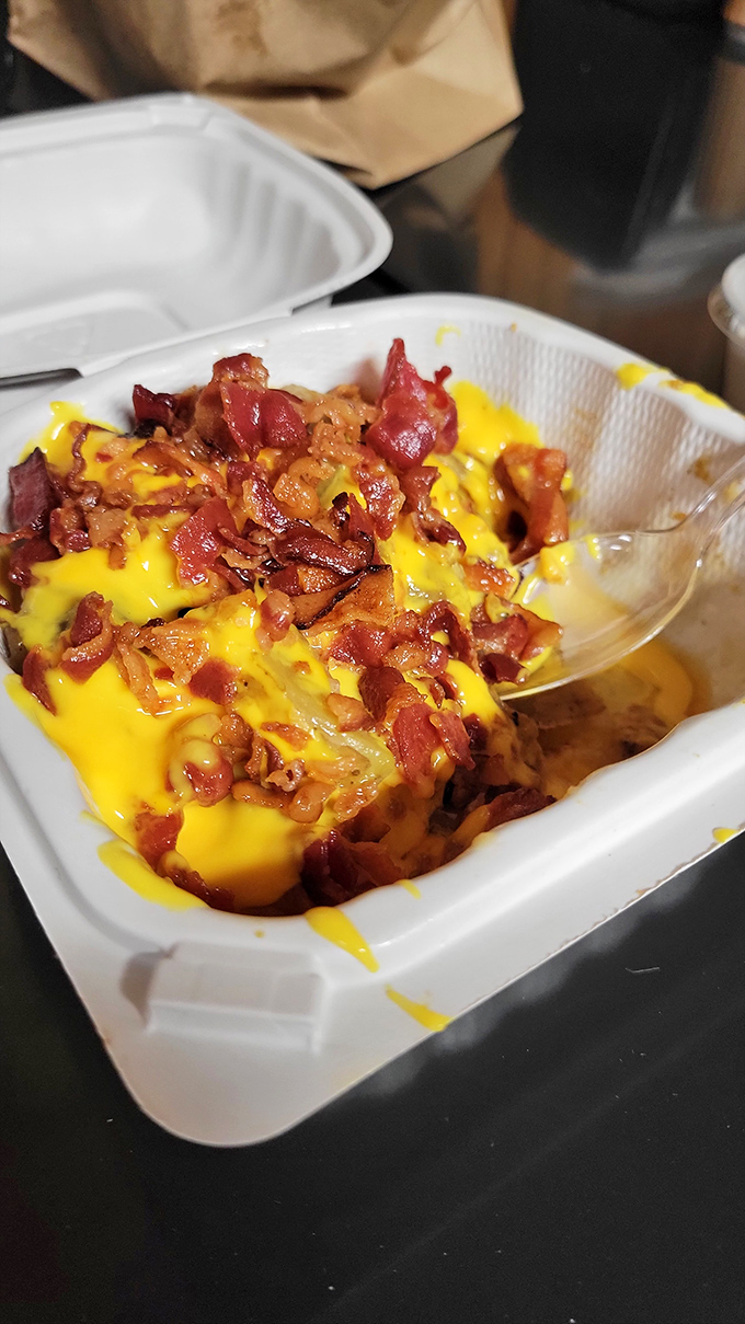 Home fries smothered in melted cheese and crispy bacon bits—proof that potatoes achieve their highest purpose at Helen's.