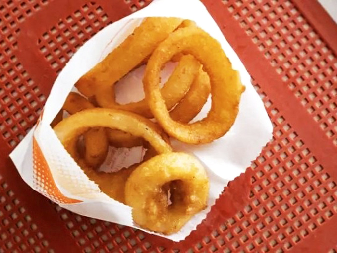 Golden halos of happiness, these onion rings aren't just side dishes—they're the supporting actors that sometimes steal the show from the main attraction.