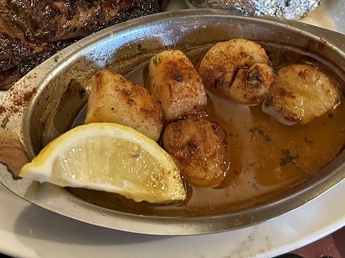 Scallops bathed in butter and kissed by flame—ocean candy that makes you wonder why you ever order anything else.