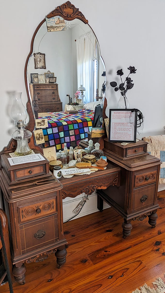 The vanity where turn-of-the-century beauty rituals happened – note the "Manifestation" sign warning visitors that mirrors might show more than your reflection.