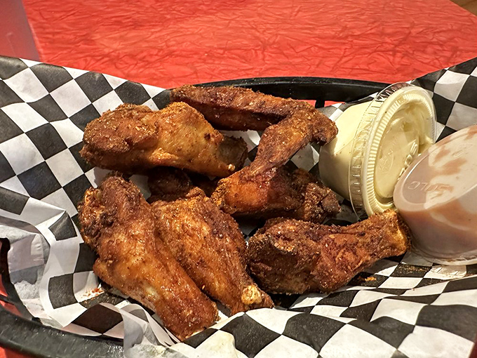 Wings that have clearly been introduced to smoke and spice and decided to start a beautiful relationship. The sauce cups are just there to chaperone.