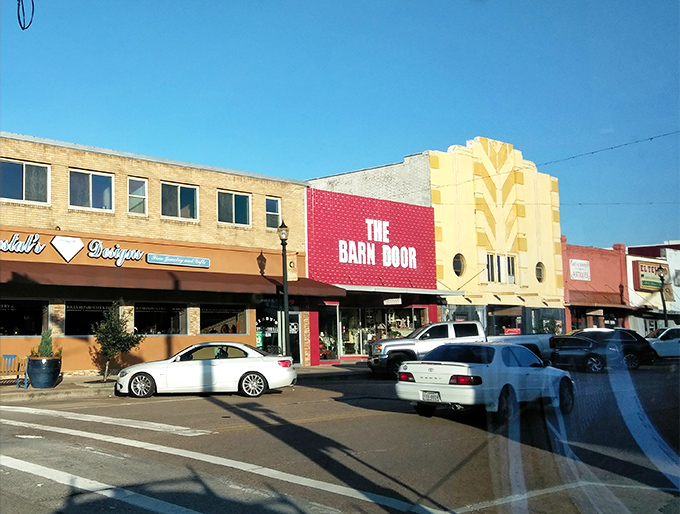 The Barn Door's striking red facade and vintage theater-style signage steals the show on this Rosenberg street corner.