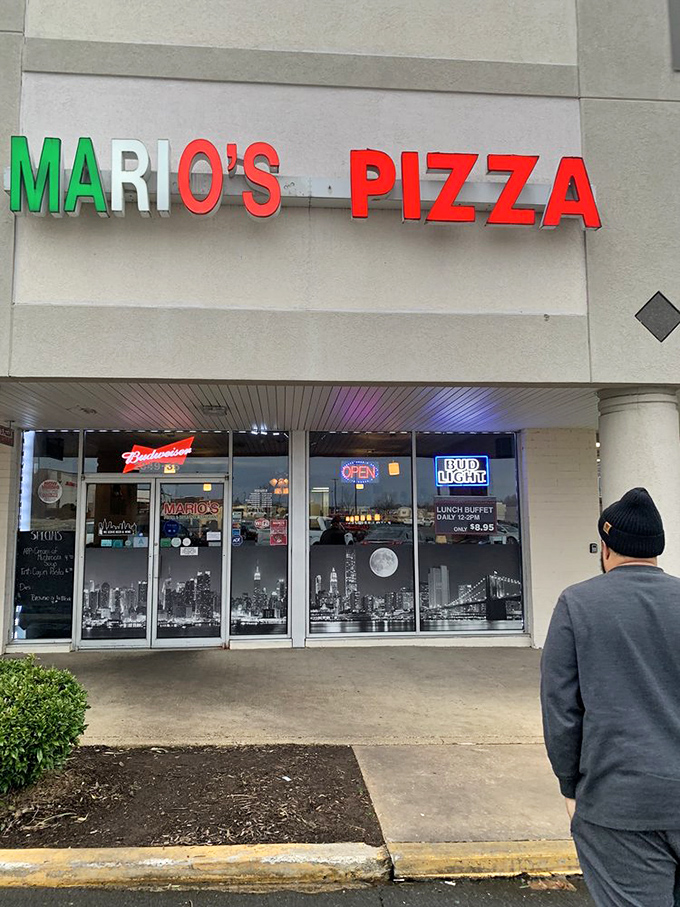 Mario's vibrant red and green signage pays homage to its Italian roots, while the New York skyline mural hints at its pizza style.