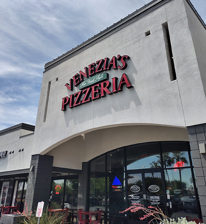 Venezia's clean white storefront is like a blank canvas—the real masterpiece is the New York-style pizza waiting inside. No subway ride required!