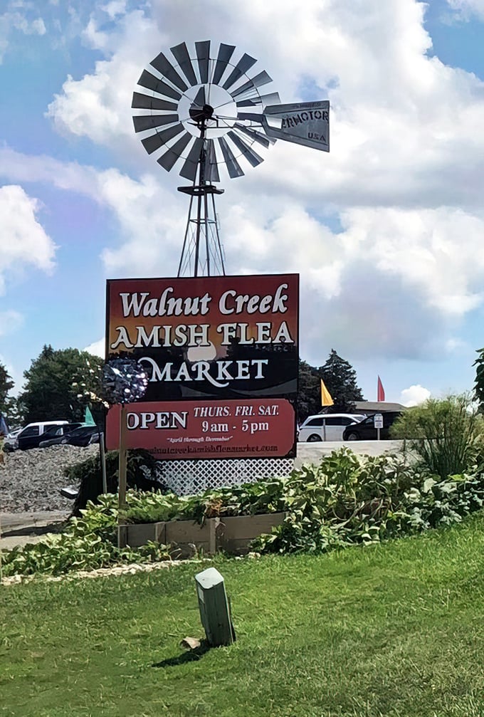 Walnut Creek's windmill sign stands tall against blue skies—a beacon for those seeking authentic Amish craftsmanship.