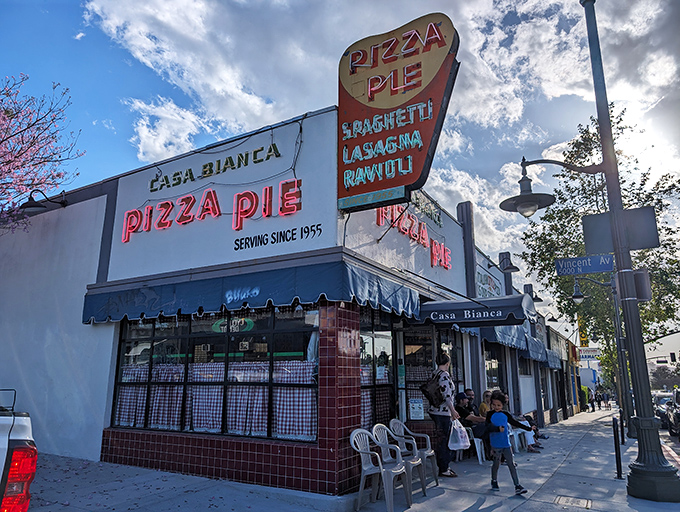 The classic red-checkered curtains and neon glow of Casa Bianca promise an old-school pizza experience that time hasn't changed – thankfully.