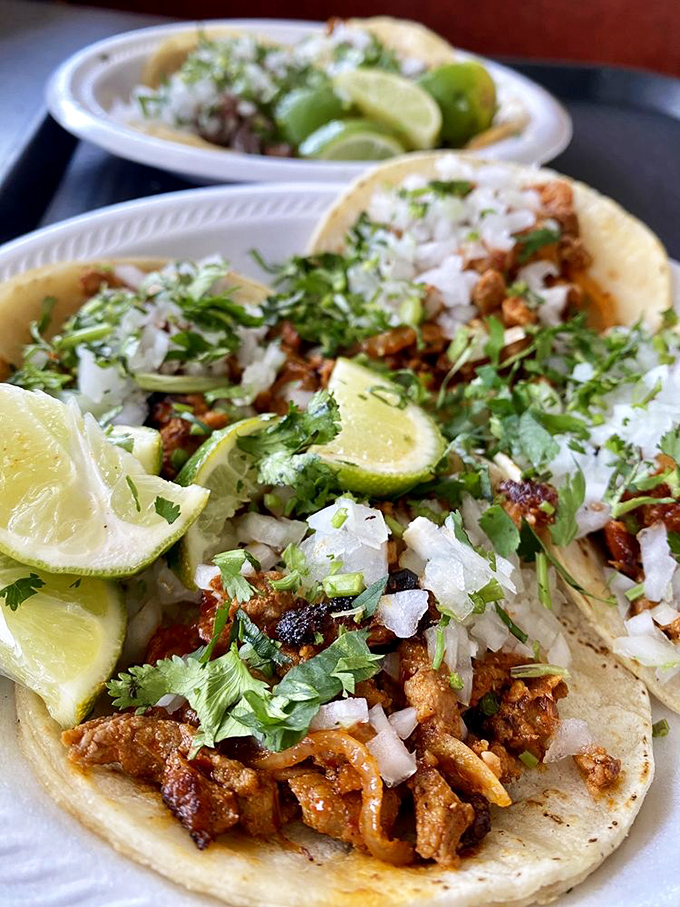 Tacos dressed in their Sunday best – cilantro, onion, and lime creating the holy trinity of taco perfection. One bite and you'll understand why people drive for hours.